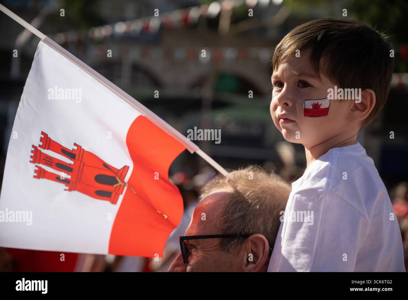 A boy holds a Gibraltar flag during National Day celebrations in the ...