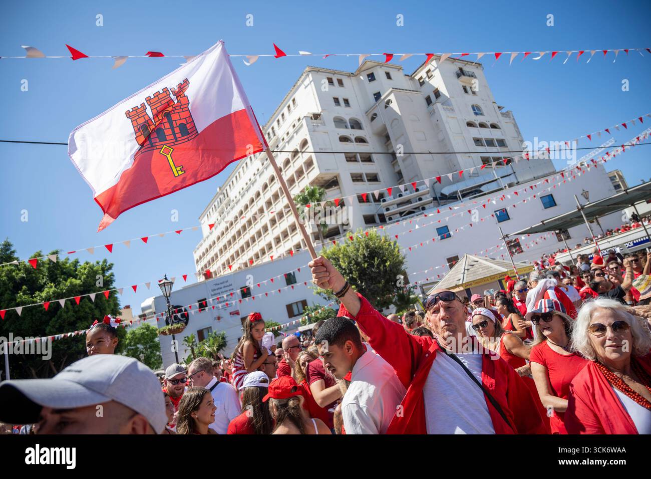 A man holds a Gibraltar flag during National Day celebrations in the ...