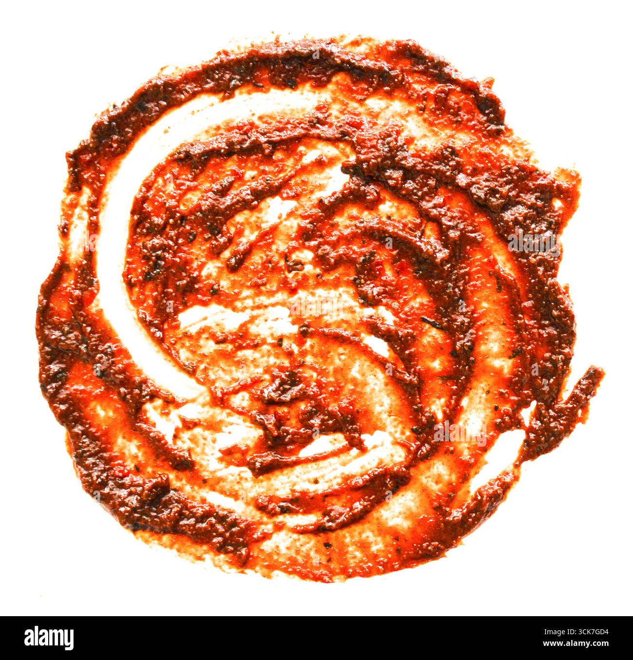 A circular swirl of a rich, reddish-brown sauce or paste, possibly used ...