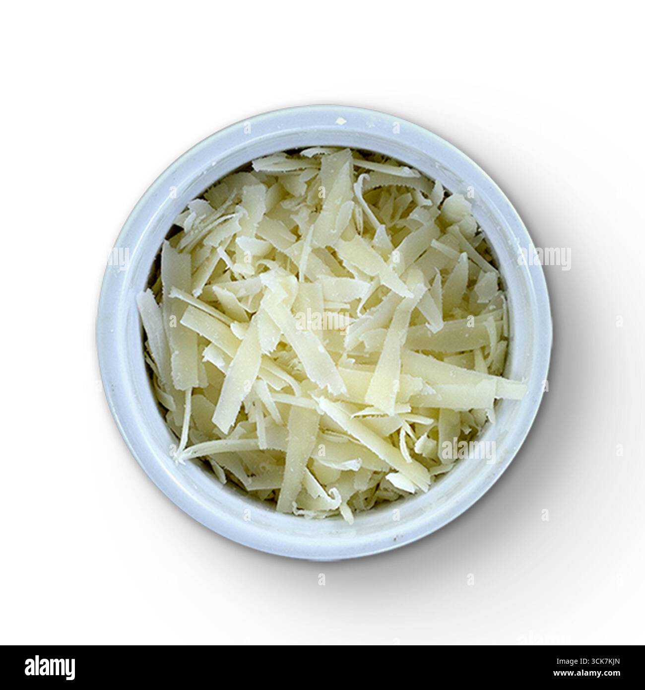 A small dish filled with finely shredded cheese, likely used as a ...