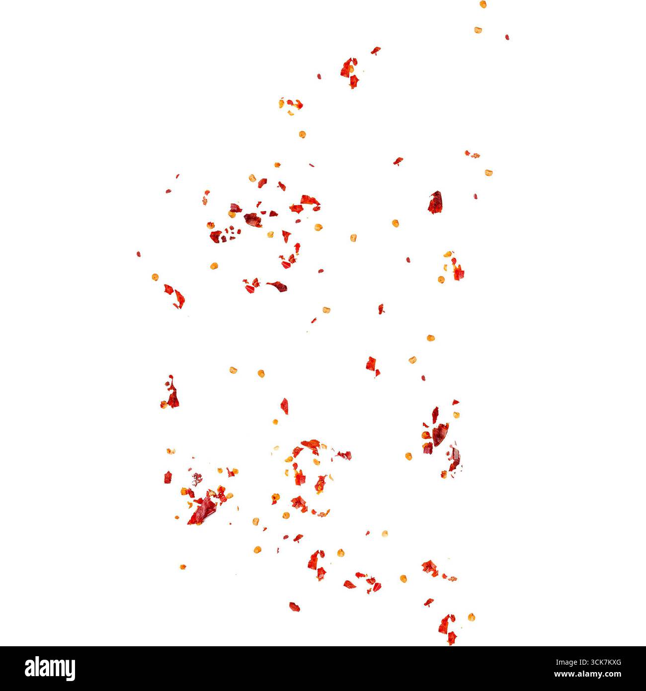 A collection of red and orange chili flakes scattered on a white ...