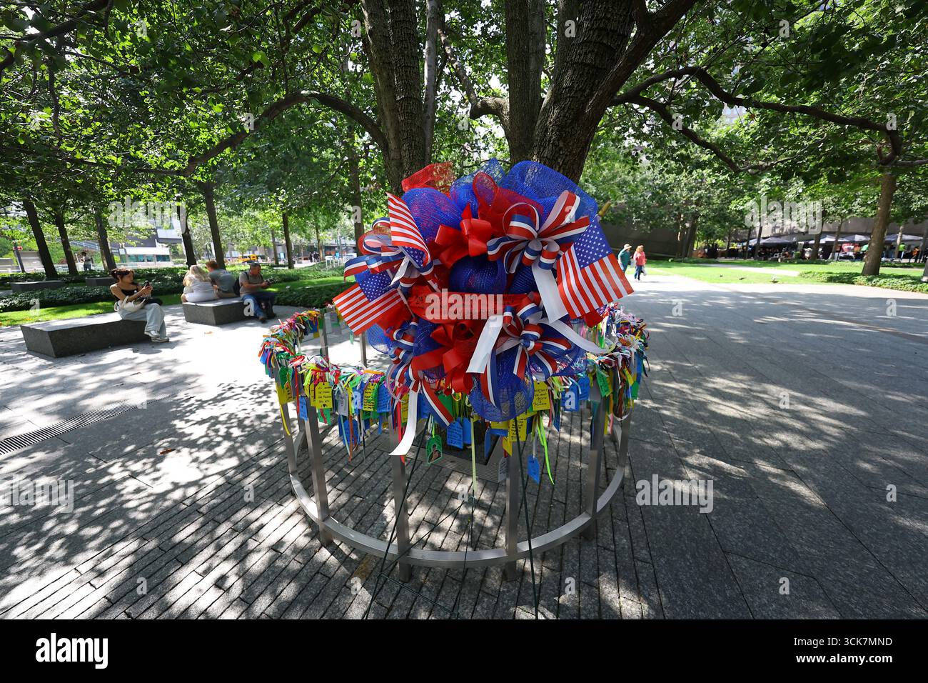 Names and ribbons are pinned around the Survivor Tree at the National ...