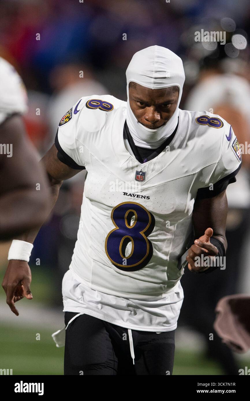 Baltimore Ravens quarterback Lamar Jackson (8) runs off the field after ...