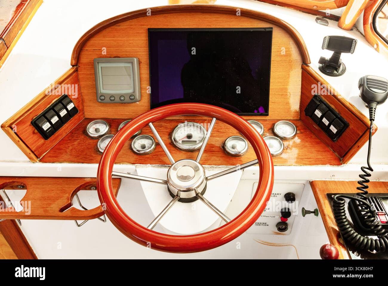 Luxury yacht control panel with steering wheel, gear levers, navigation ...