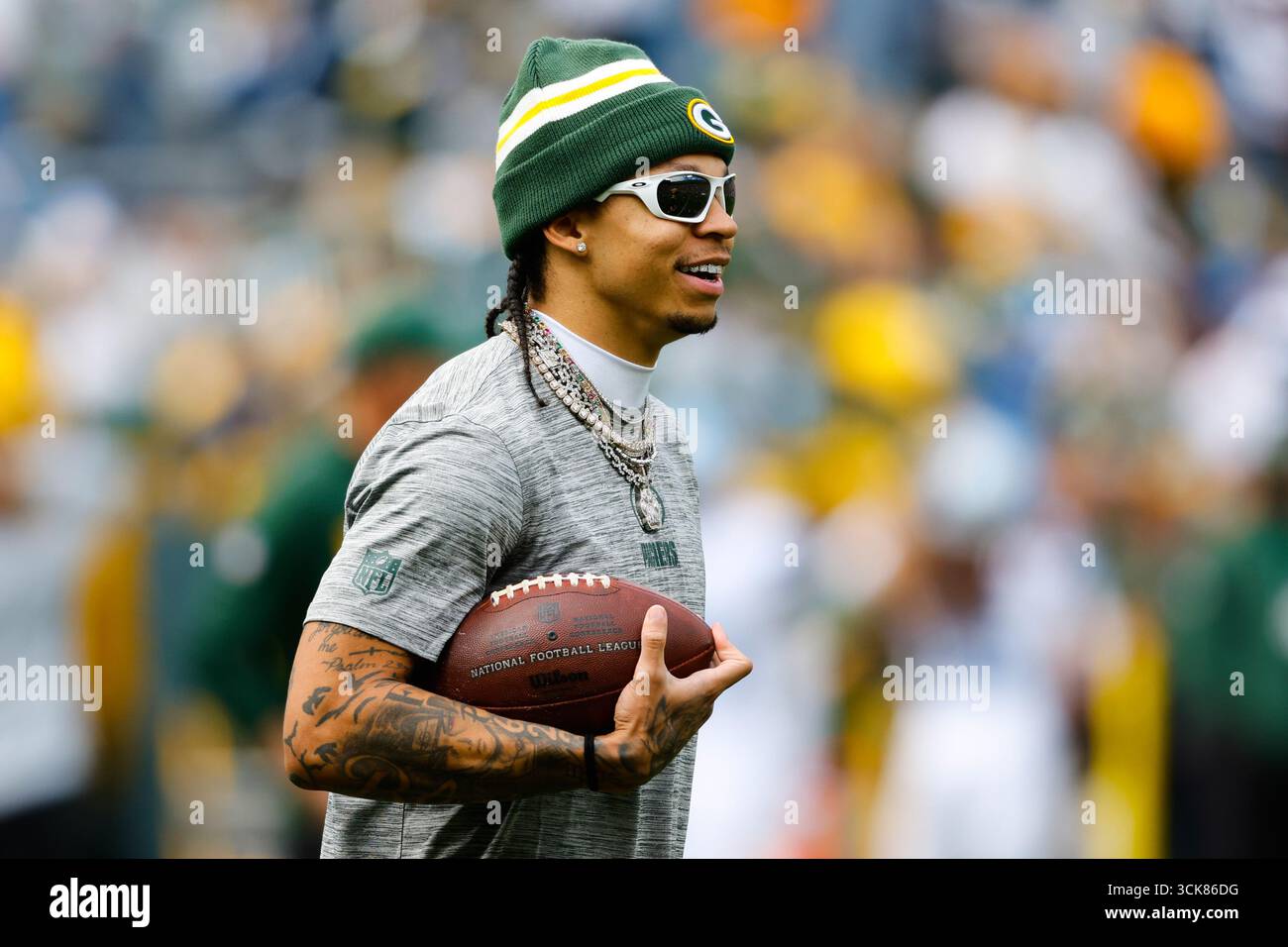 FILE - Green Bay Packers' Christian Watson walks on the field before a ...