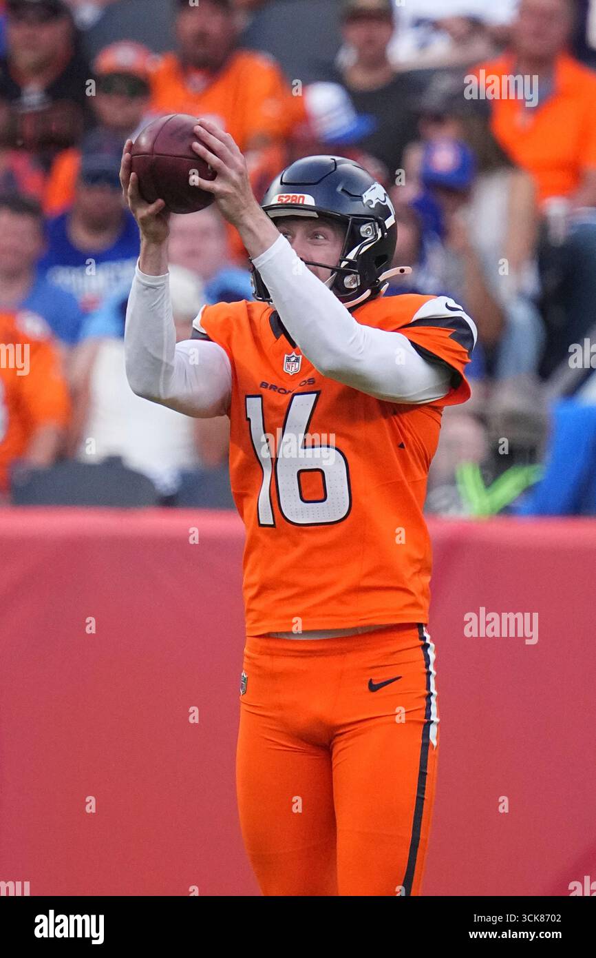 Denver Broncos punter Jeremy Crawshaw (16) punts the ball against the ...