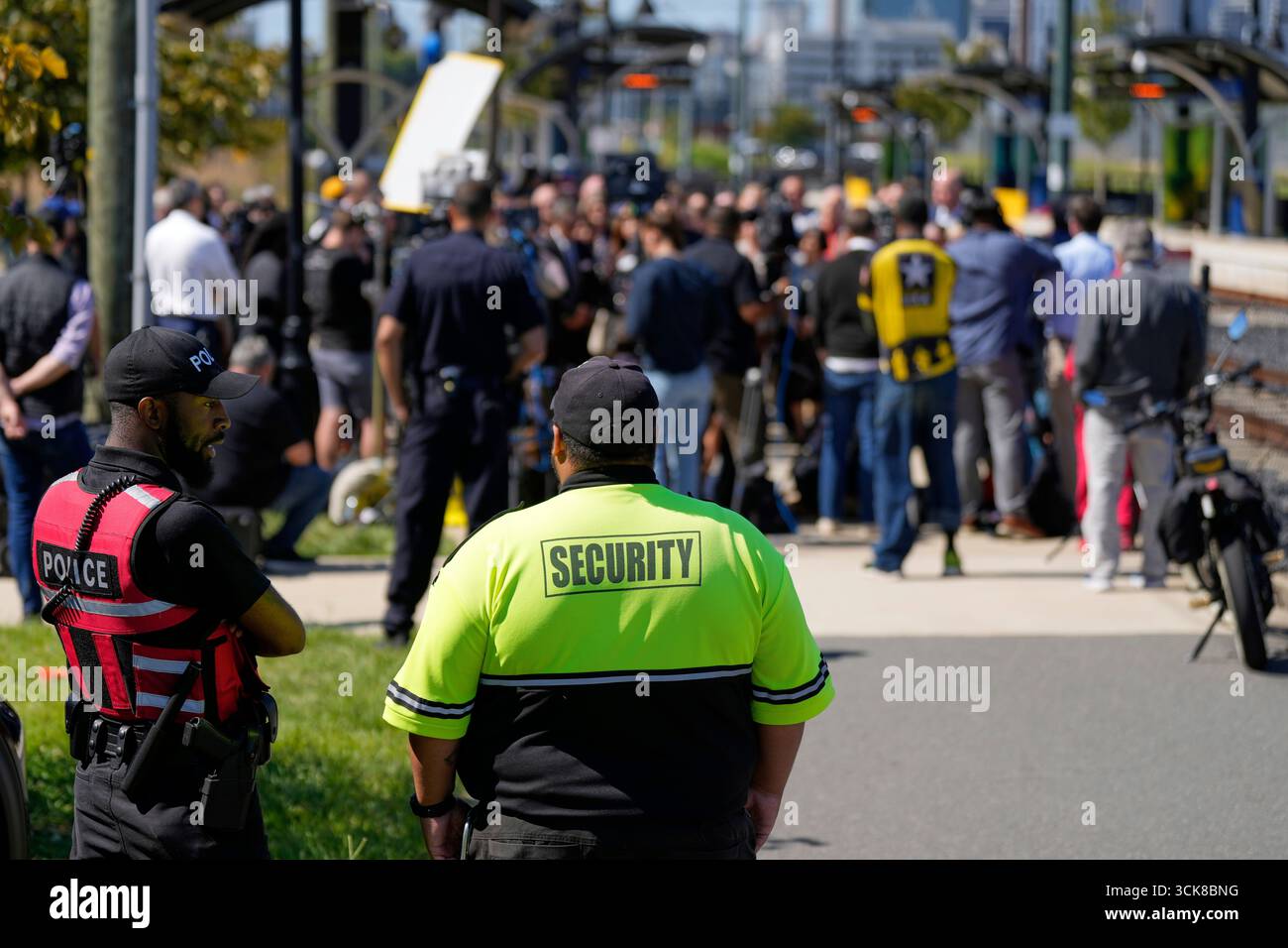 Charlotte Area Transportation security officers watch on during a news ...