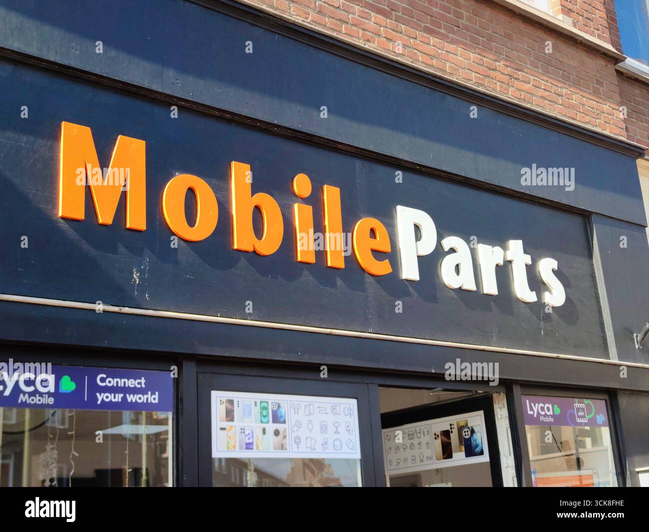 Close-Up of a Storefront Featuring Mobile Parts and Accessories Signage ...