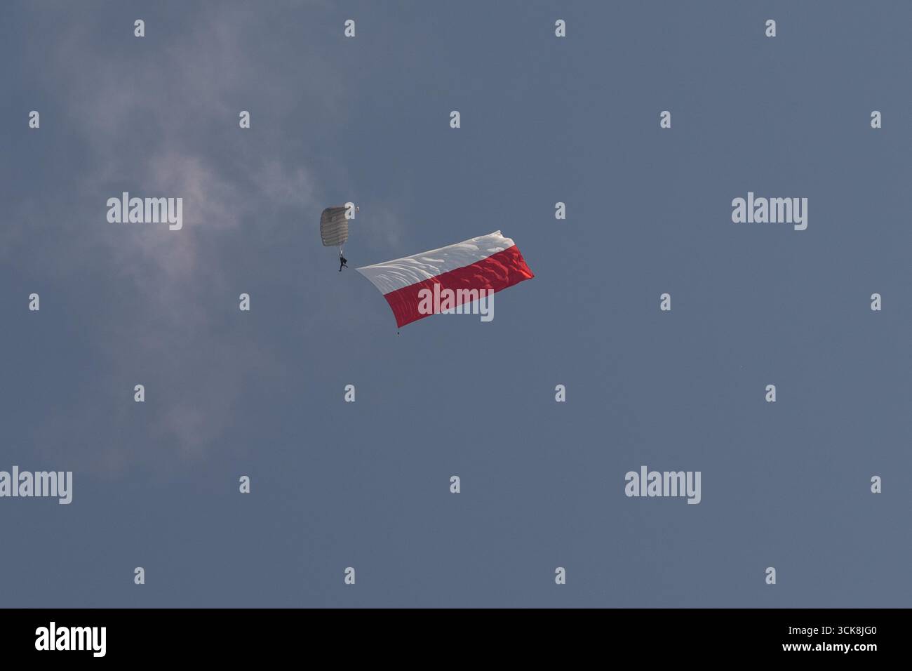 A military parachutist performs a jump with the Polish national flag ...
