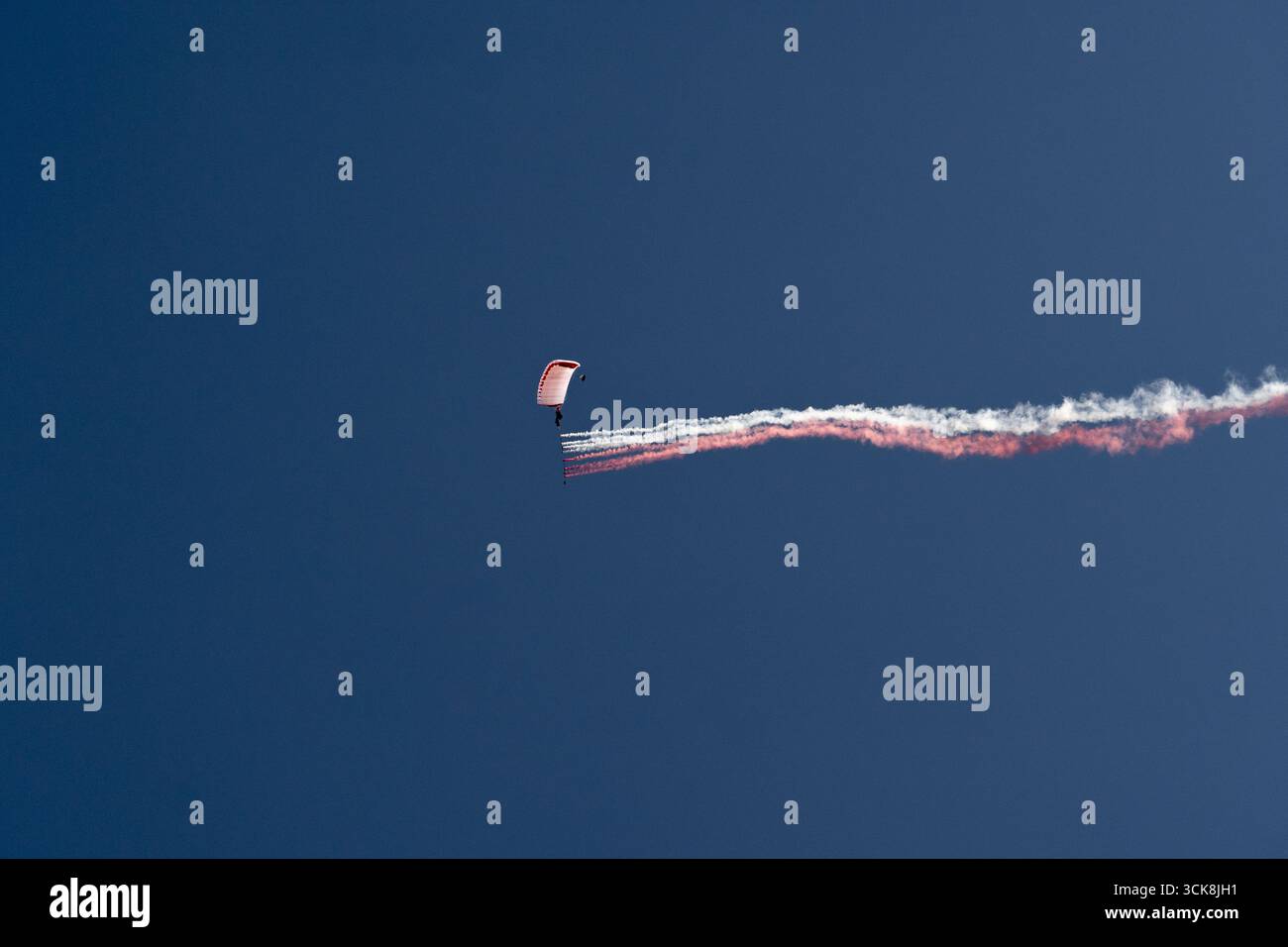 A military parachutist performs a jump with the Polish national flag ...