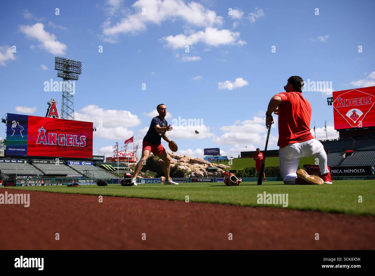 Los Angeles Angels shortstop Zach Neto, left,warms up before a baseball ...