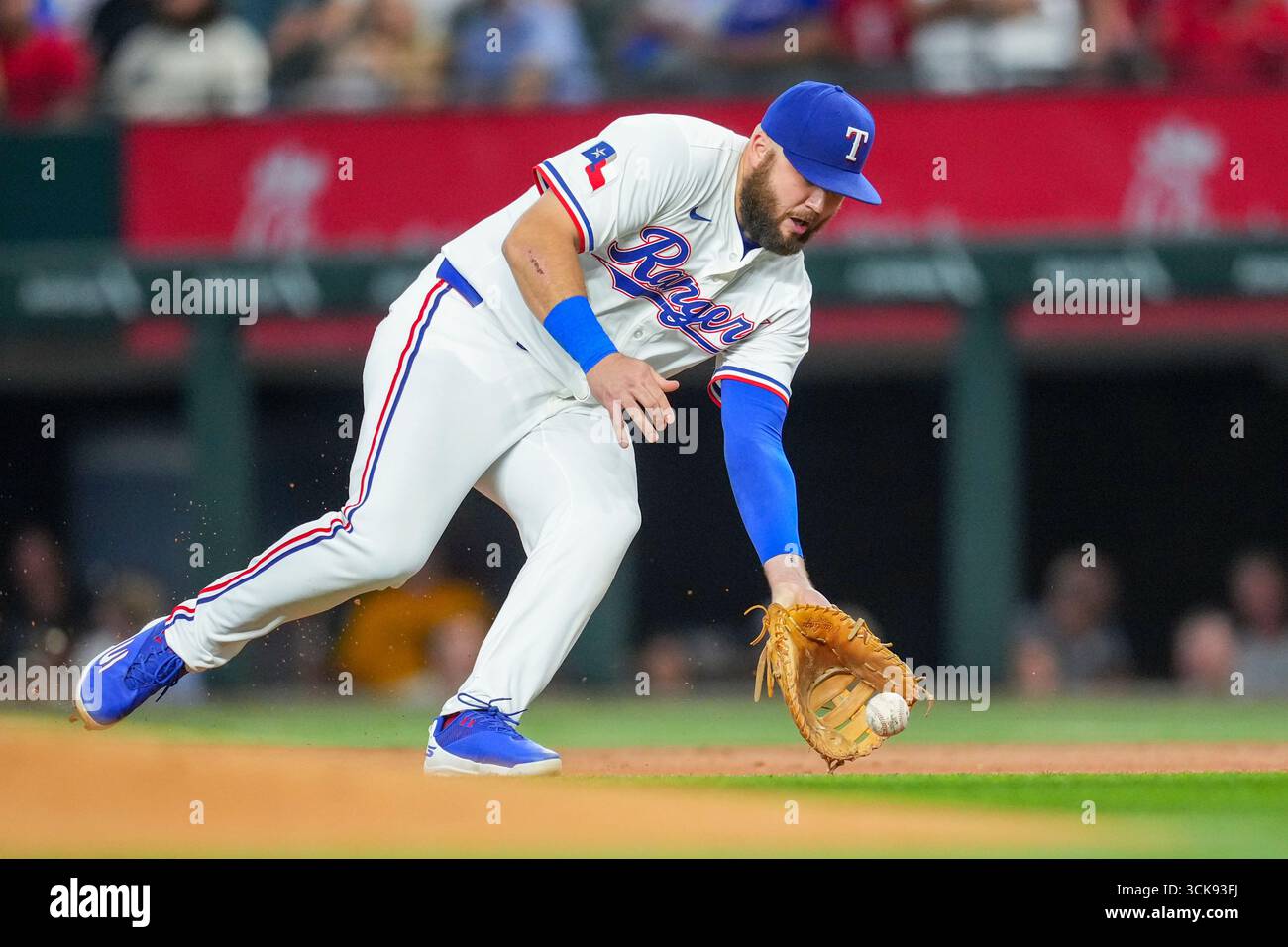 Texas Rangers first base Jake Burger fields a groundout by Milwaukee ...