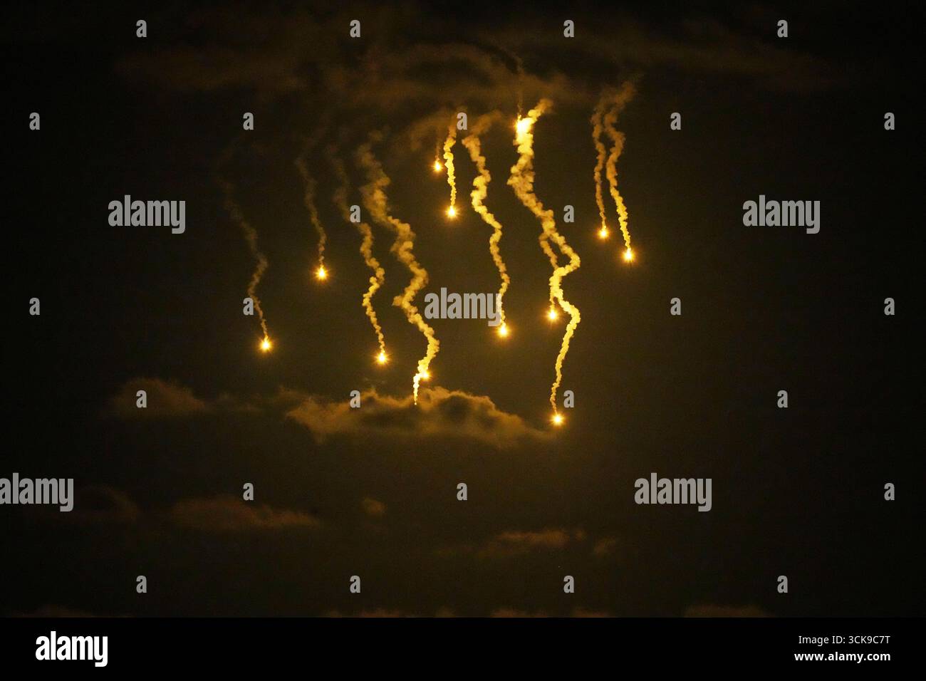 Illumination flares launched by the Israeli army are seen over Deir al ...