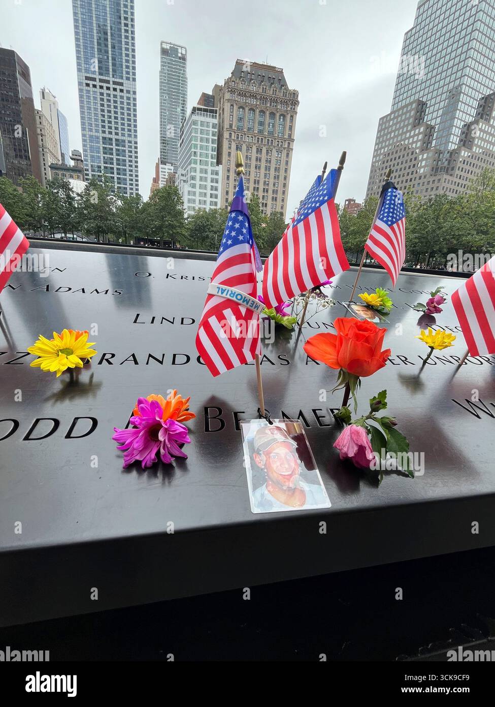 Flags and flowers are placed in the inscribed names at the National ...