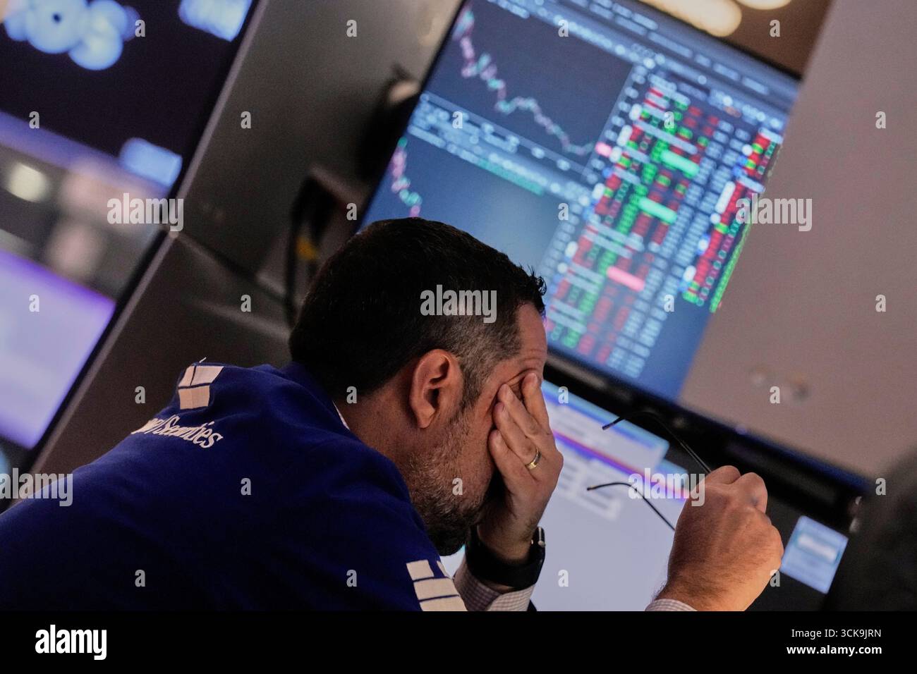 Specialist Brian Fairbrother works on the floor of the New York Stock ...