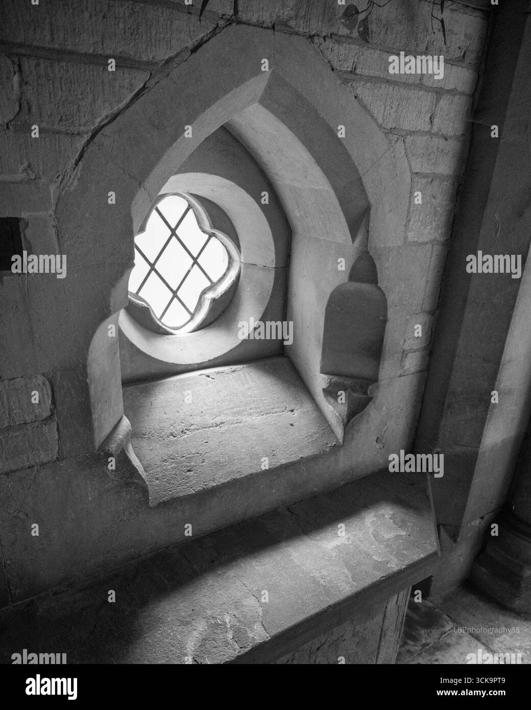 Stone gothic-style church window with geometric tracery detail ...