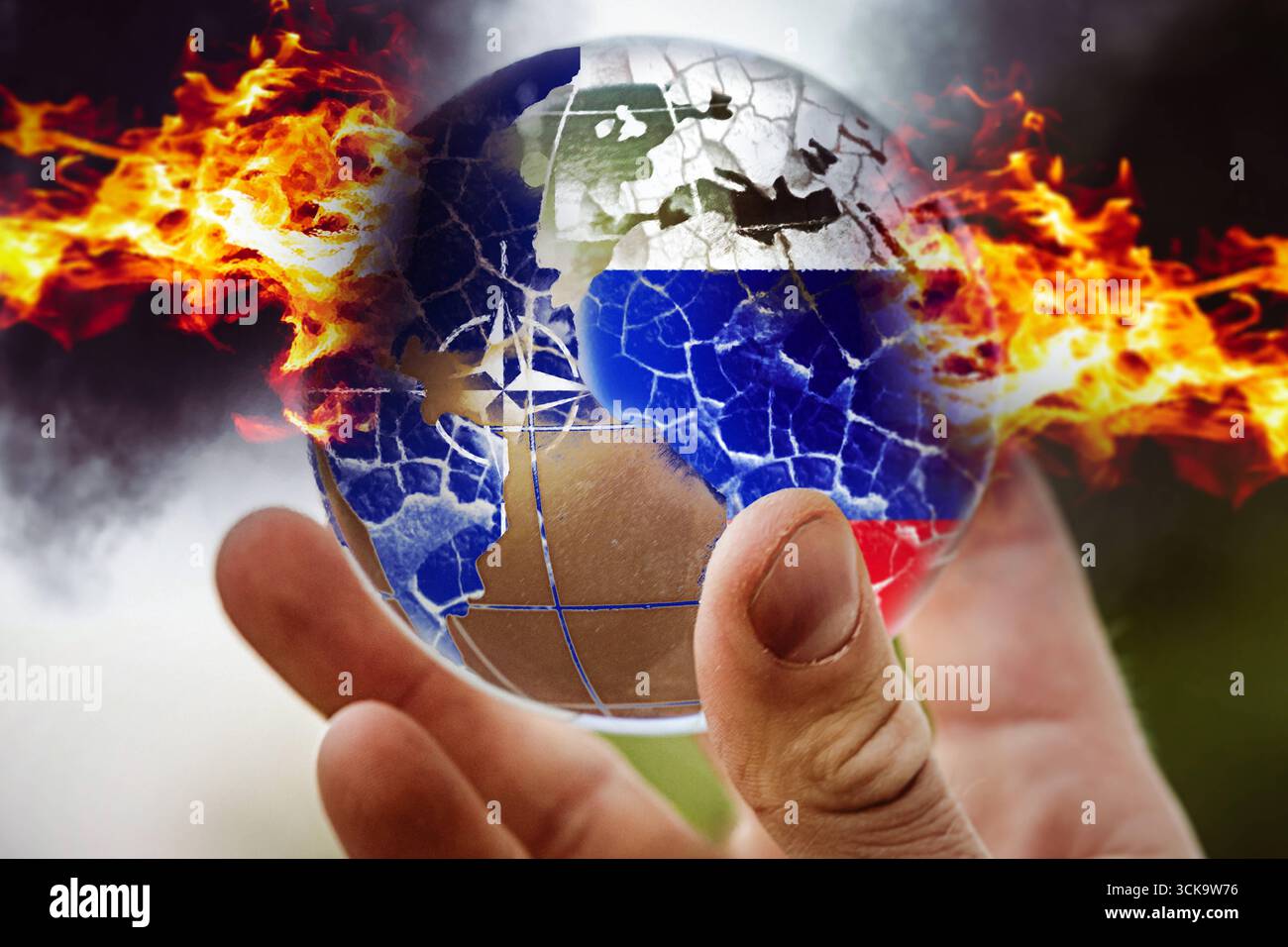 Germany - September 10, 2025: PHOTOMONTAGE, A hand holds a burning and broken globe on fire with ...