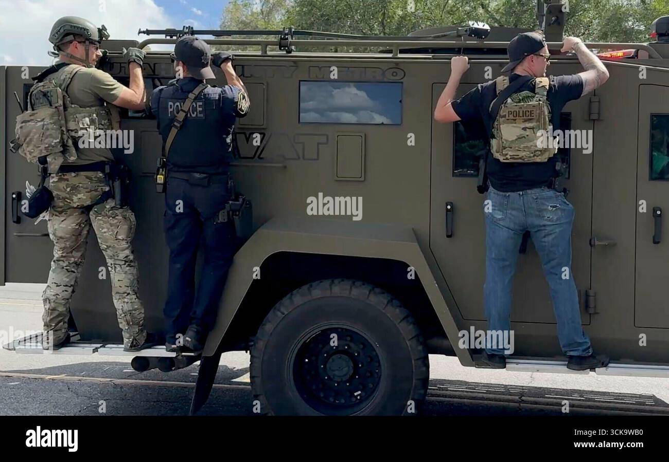 In this image taken from video, SWAT heads into campus after Charlie ...