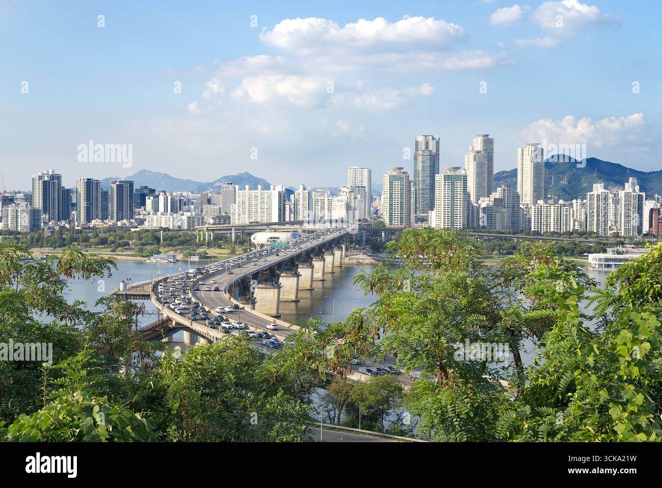 Cars and traffic on Cheongdam Bridge on a clear sunny afternoon viewed ...