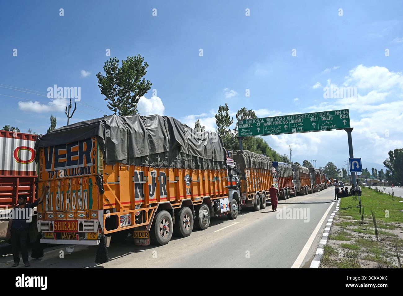 SRINAGAR, INDIA - SEPTEMBER 10: Trucks carrying apples are seen ...