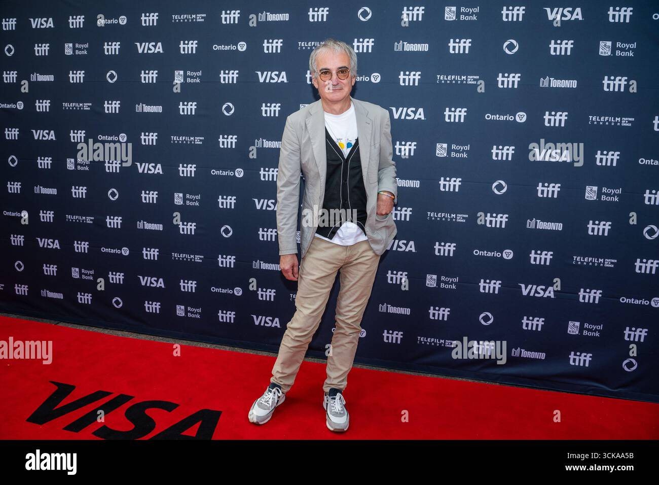 Director Oliver Assayas arrives on the red carpet for "The Wizard of ...