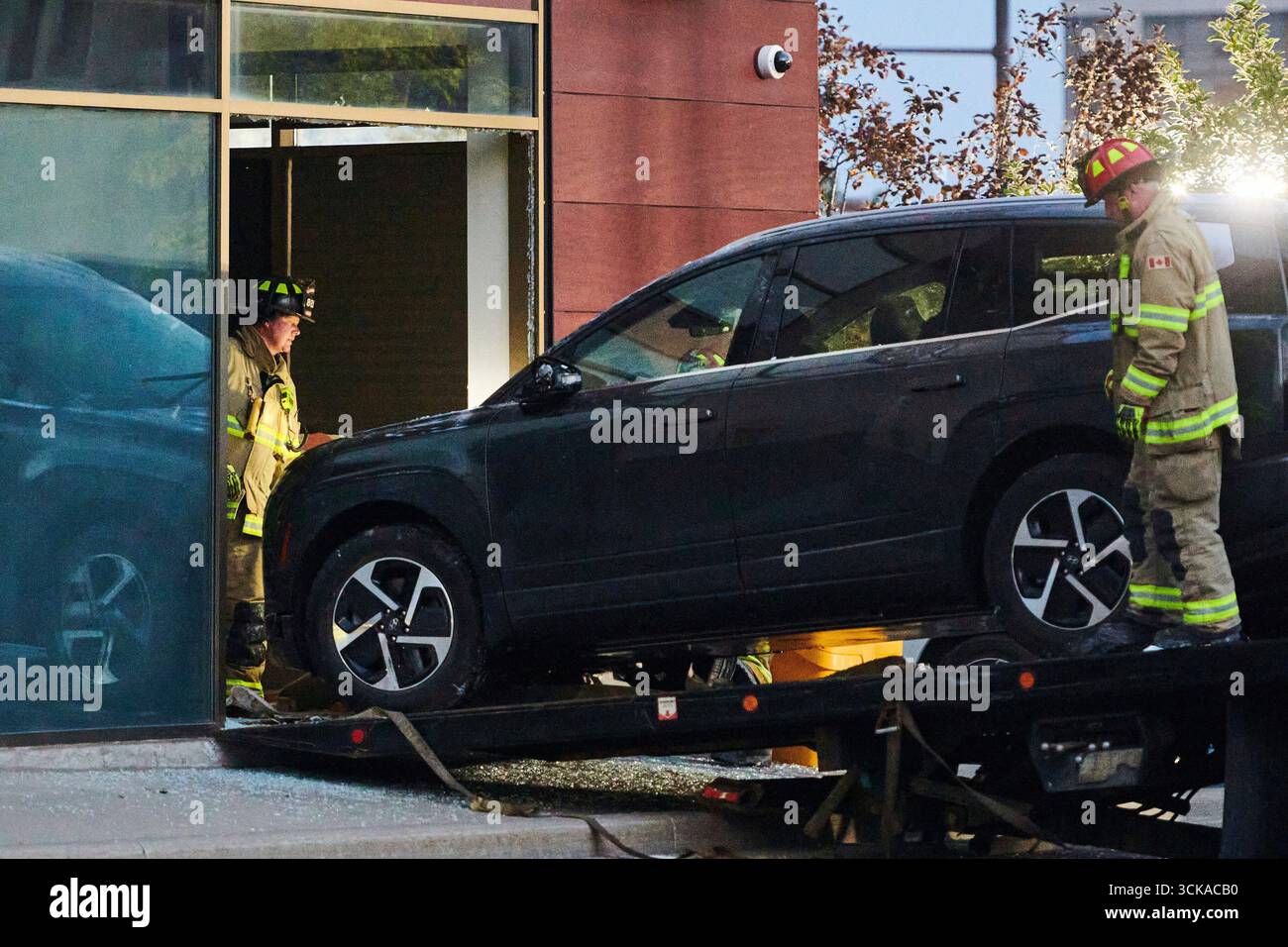 Police and fire crews work to remove a vehicle from First Roots Early ...
