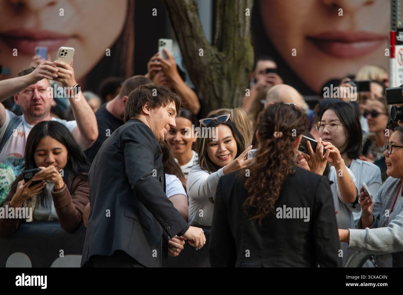 Paul Dano greets fans before the red carpet for "The Wizard of the ...