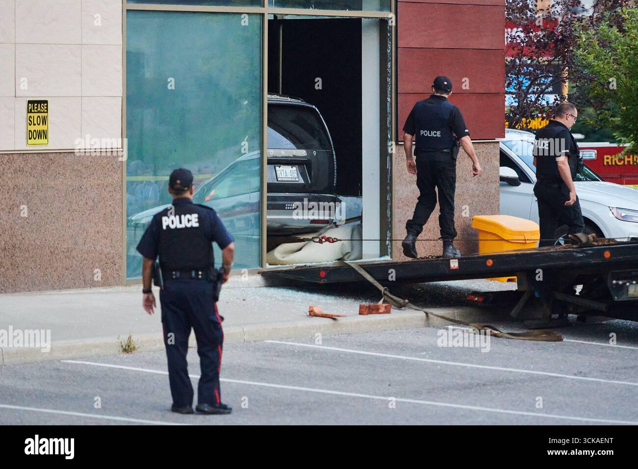Police and fire crews work to remove a vehicle from First Roots Early ...