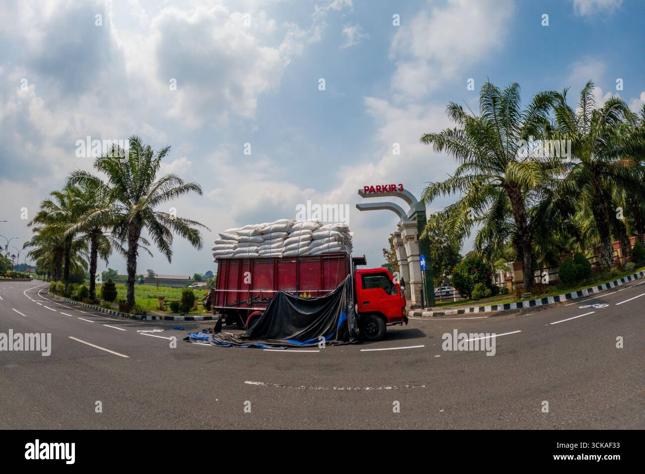 A truck carrying rice is stuck on the side of the road Stock Photo - Alamy