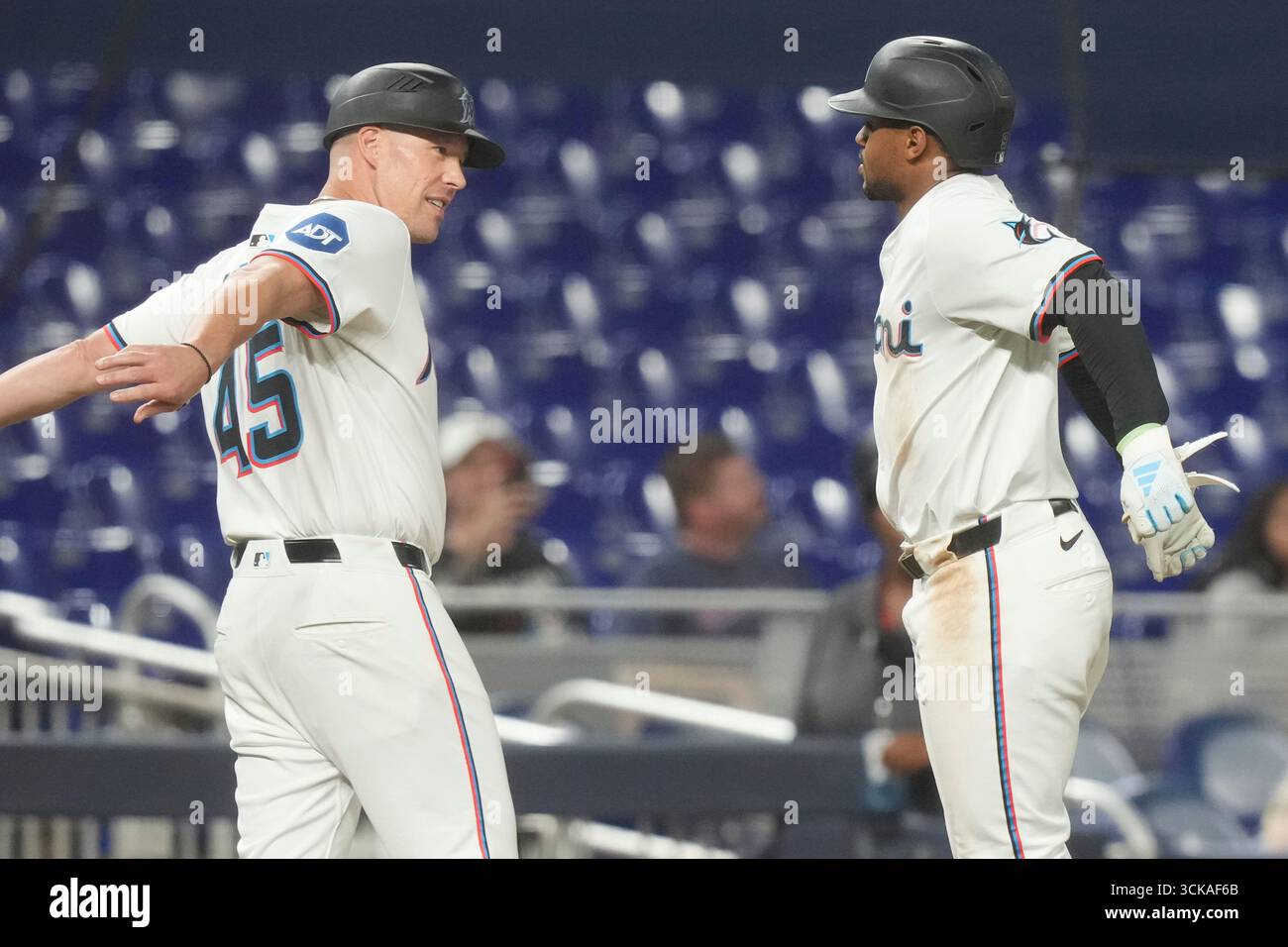 Miami Marlins' Xavier Edwards celebrates with third base coach Blake ...