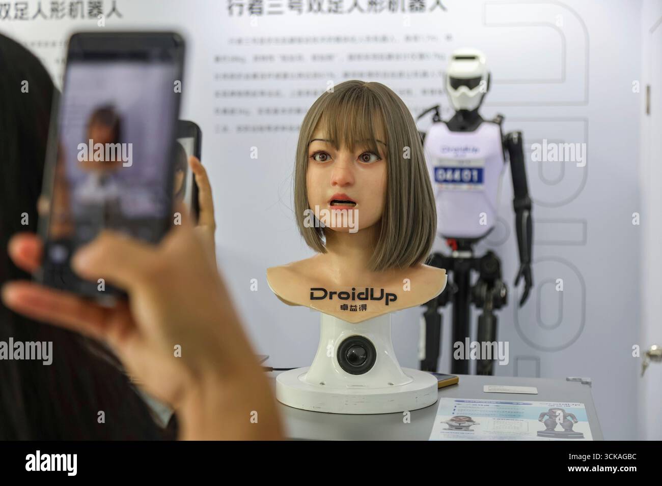 Visitors check out humanoid parts exhibited for the tech event ...