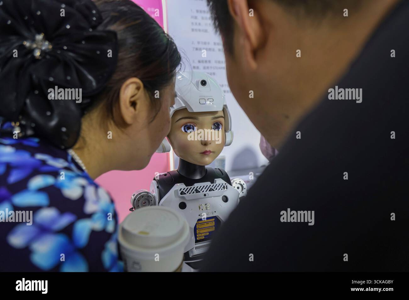Visitors check out a humanoid exhibited for the tech event Inclusion ...