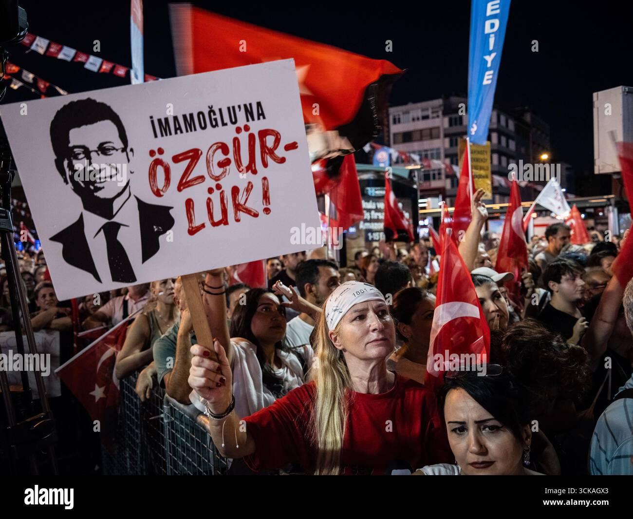 A woman holds a placard reading "Freedom for Ekrem ?mamo?lu". The CHP's "Nation Stands Up for ...