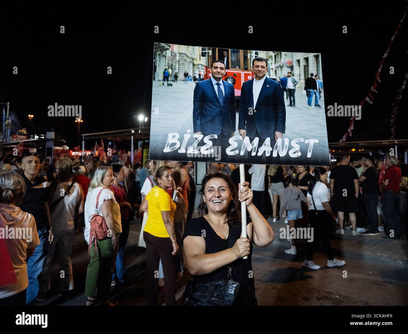 A woman holds a placard with a photo of the arrested Istanbul Metropolitan Municipality Mayor ...