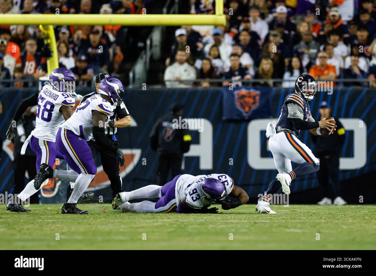 Chicago Bears quarterback Caleb Williams (18) runs with the ball past ...