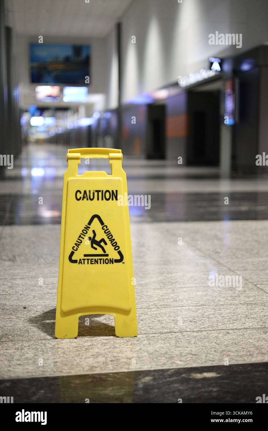 Caution sign slippery floor in the hallway Stock Photo - Alamy