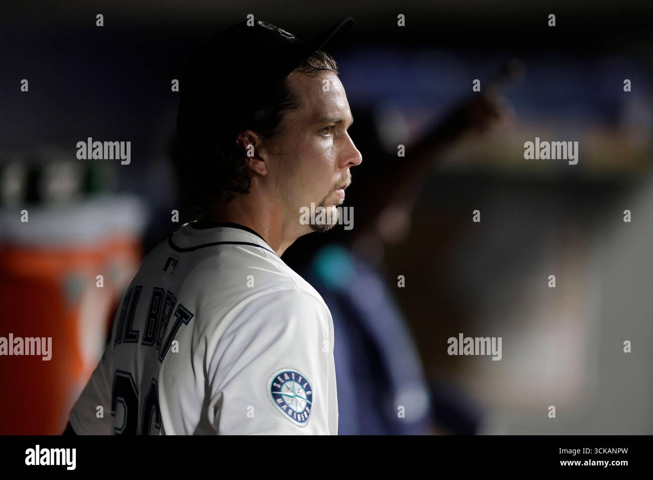 Seattle Mariners starting pitcher Logan Gilbert looks out of the dugout ...