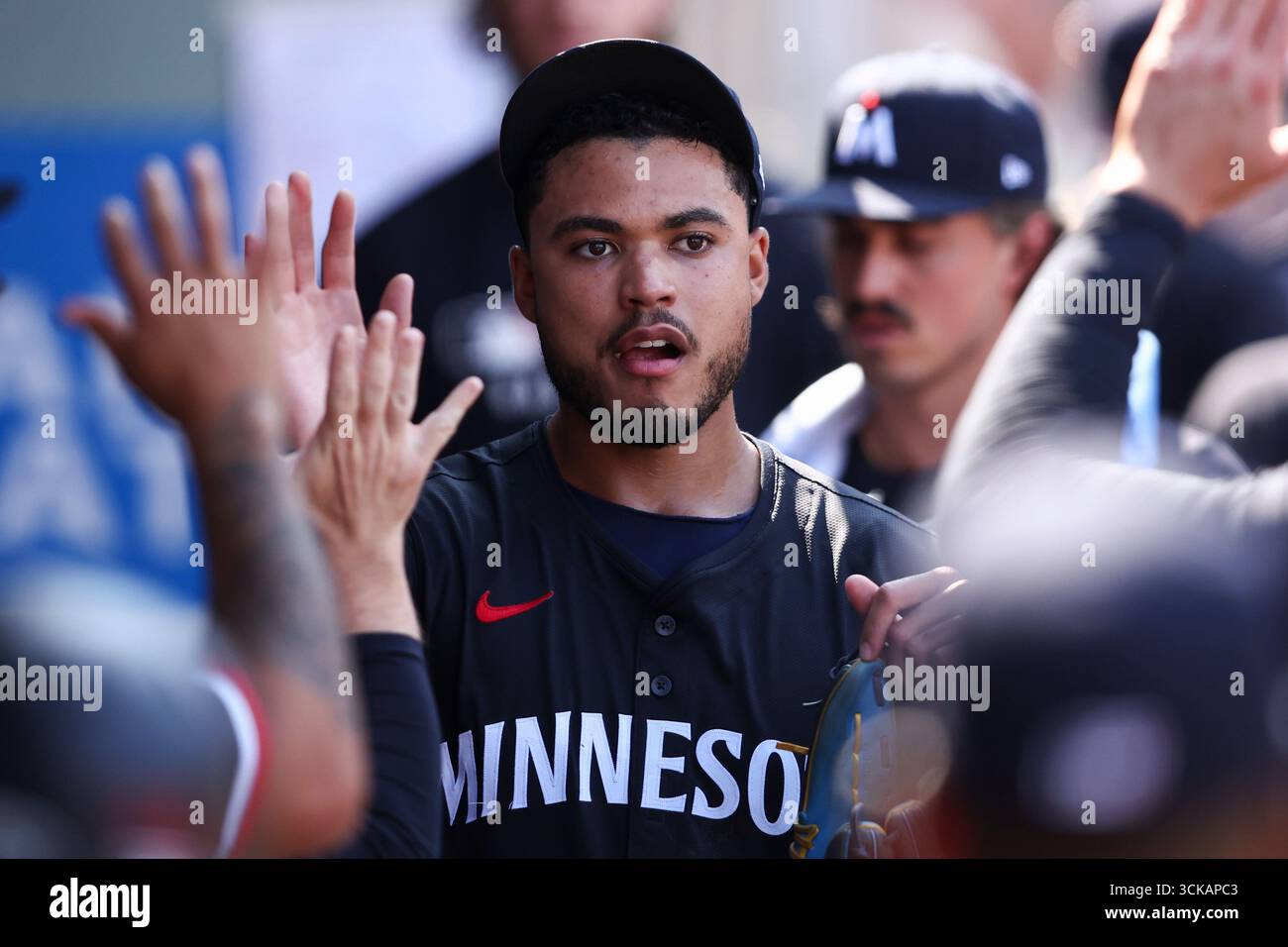 Minnesota Twins pitcher Taj Bradley high fives his teammates during the ...