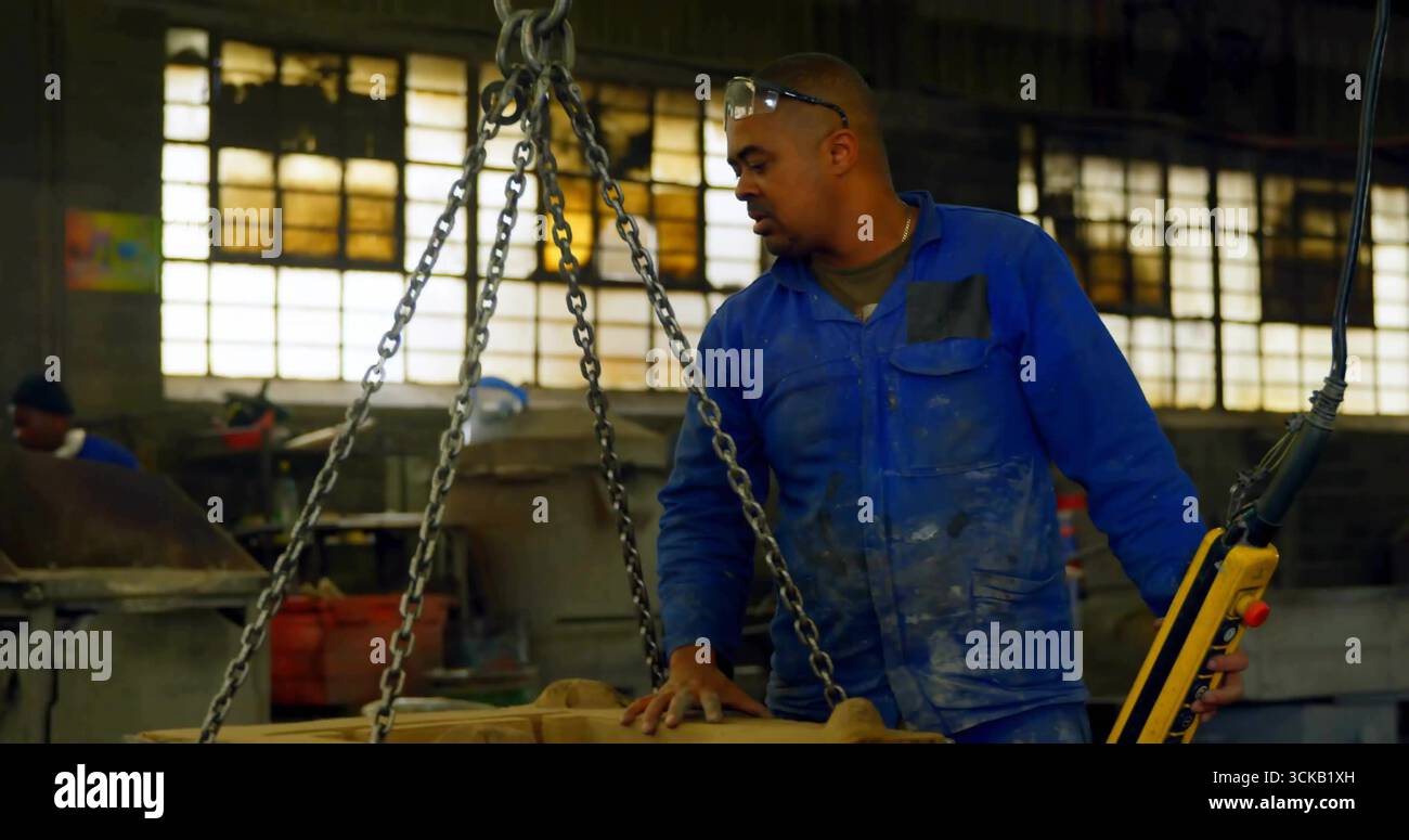 Factory worker using lifting hoist hi-res stock photography and images ...