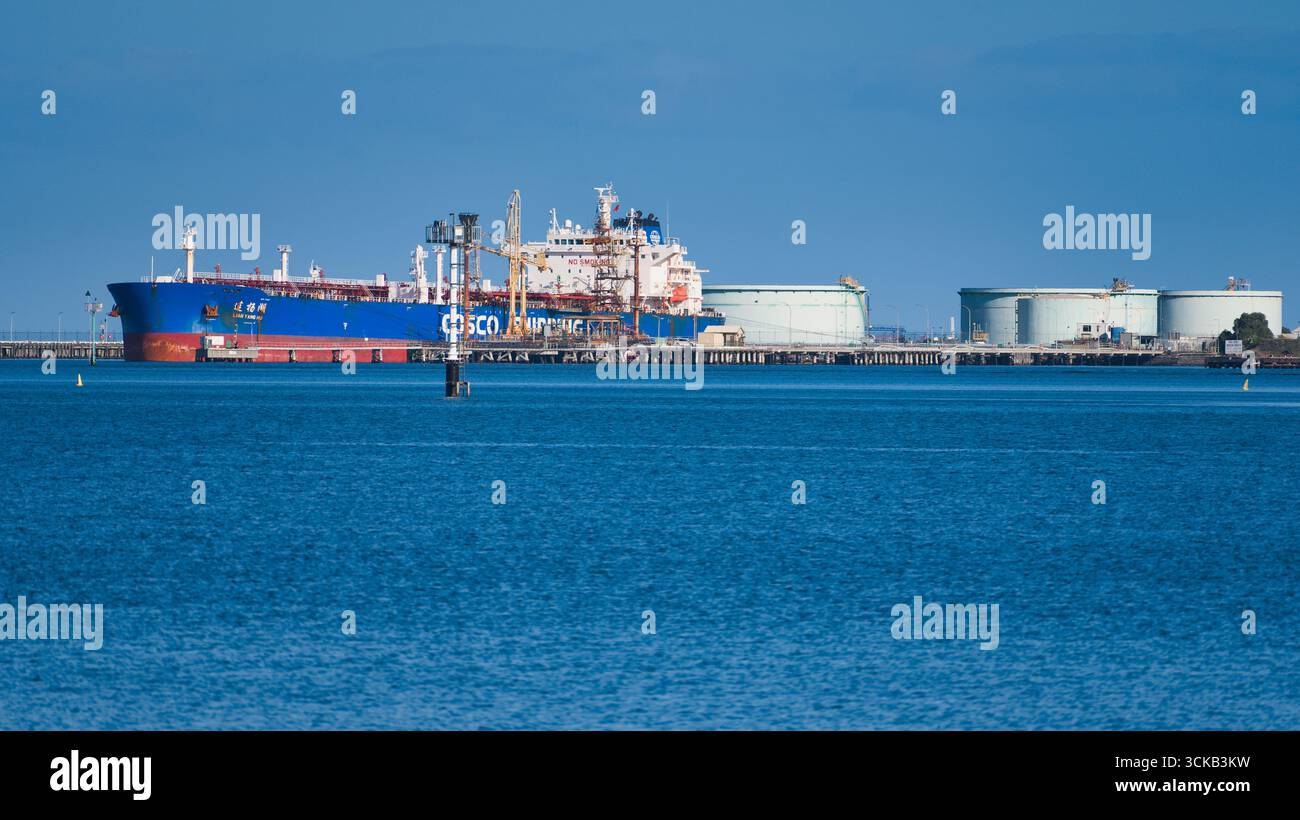Tanker moored at industrial port near fuel storage tanks in Port ...