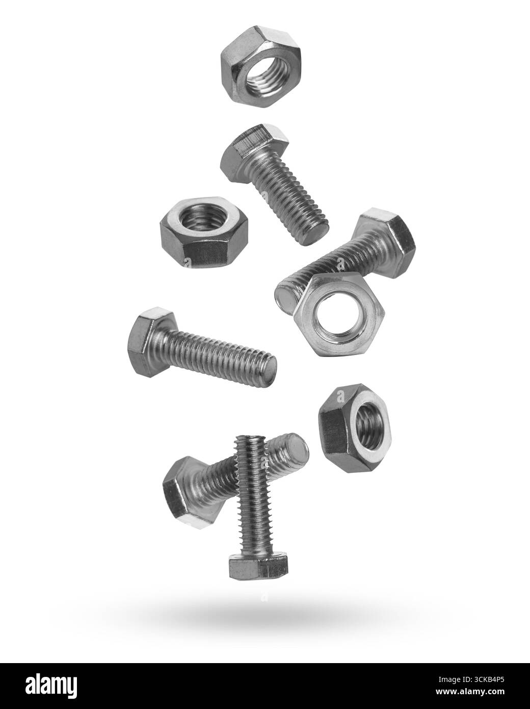 Metal nuts and bolts falling against white background Stock Photo - Alamy