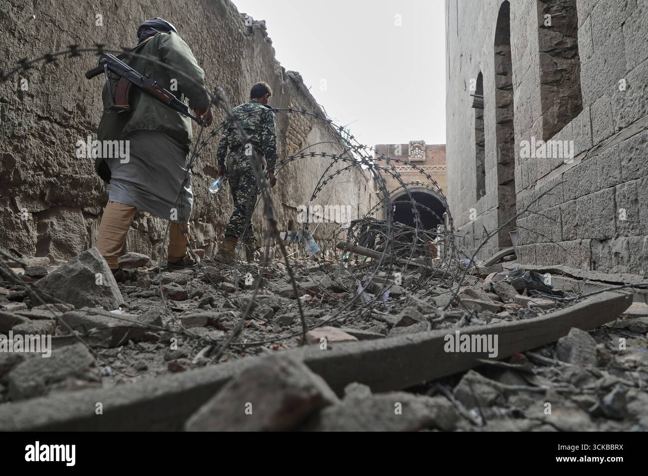 People inspect the damage at the National Museum, following the Israeli airstrikes on Wednesday ...