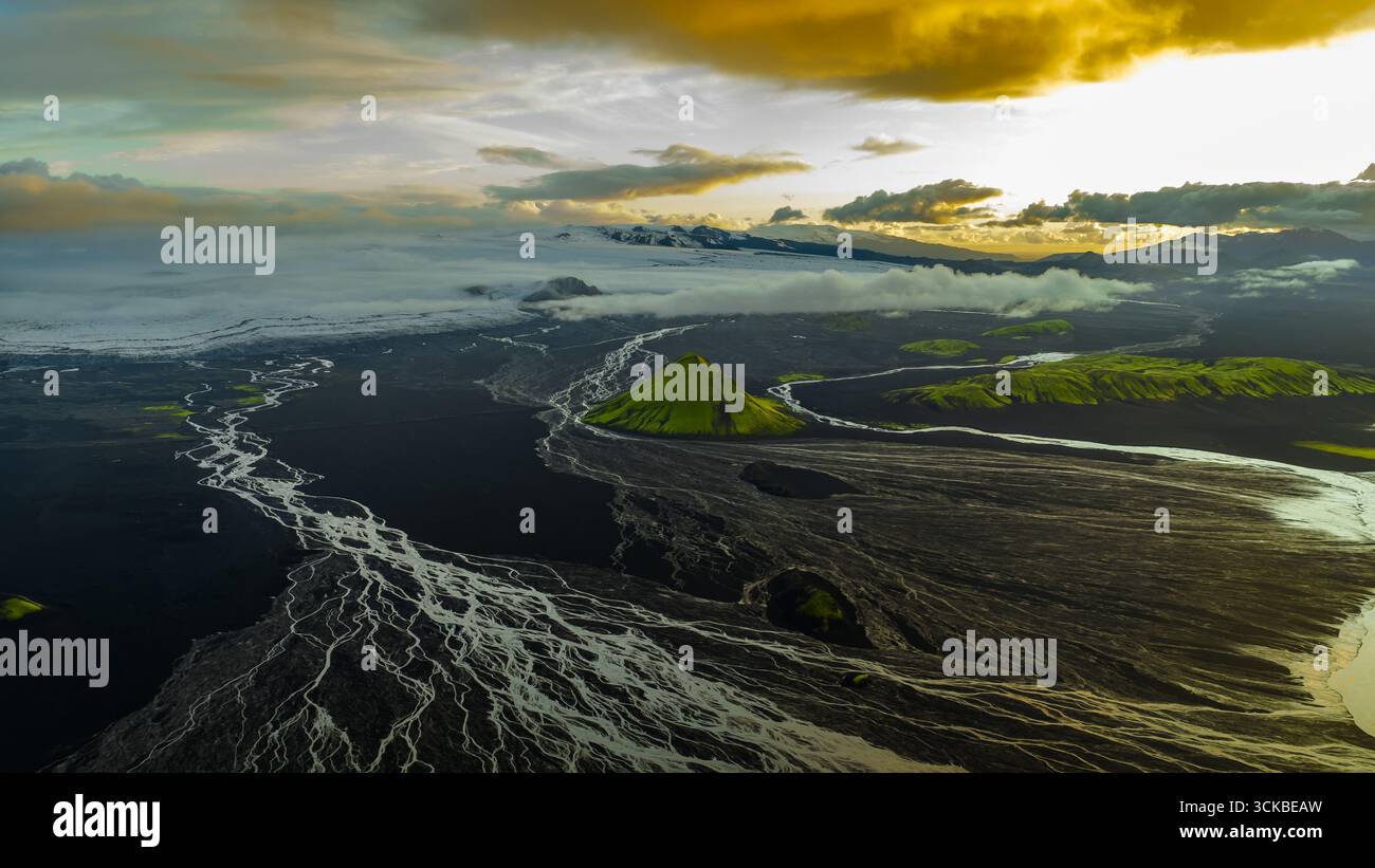 Aerial view of a green cone shaped hill in Iceland's volcanic terrain ...