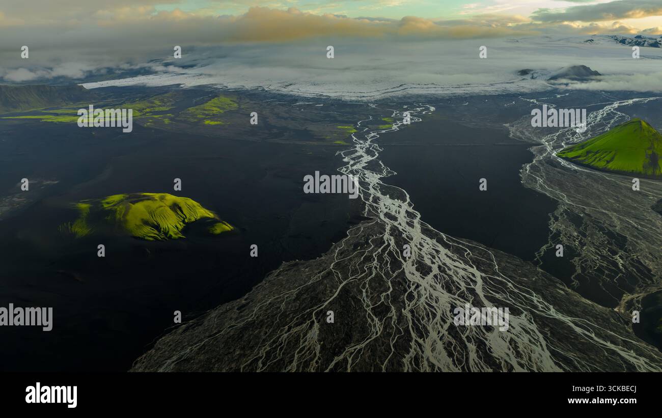 Aerial perspective of Iceland's volcanic plains with braided white ...