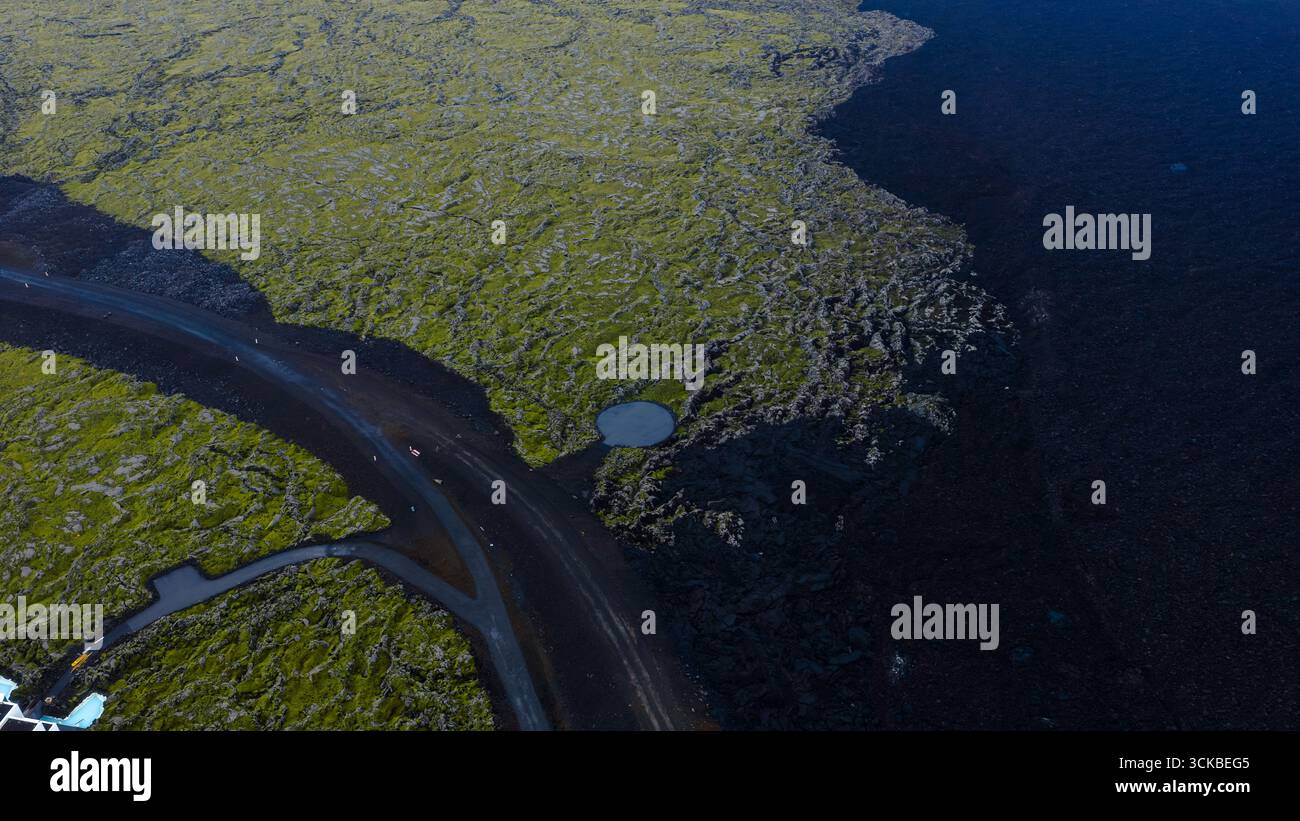 Aerial image of Iceland's volcanic terrain featuring dark lava fields ...