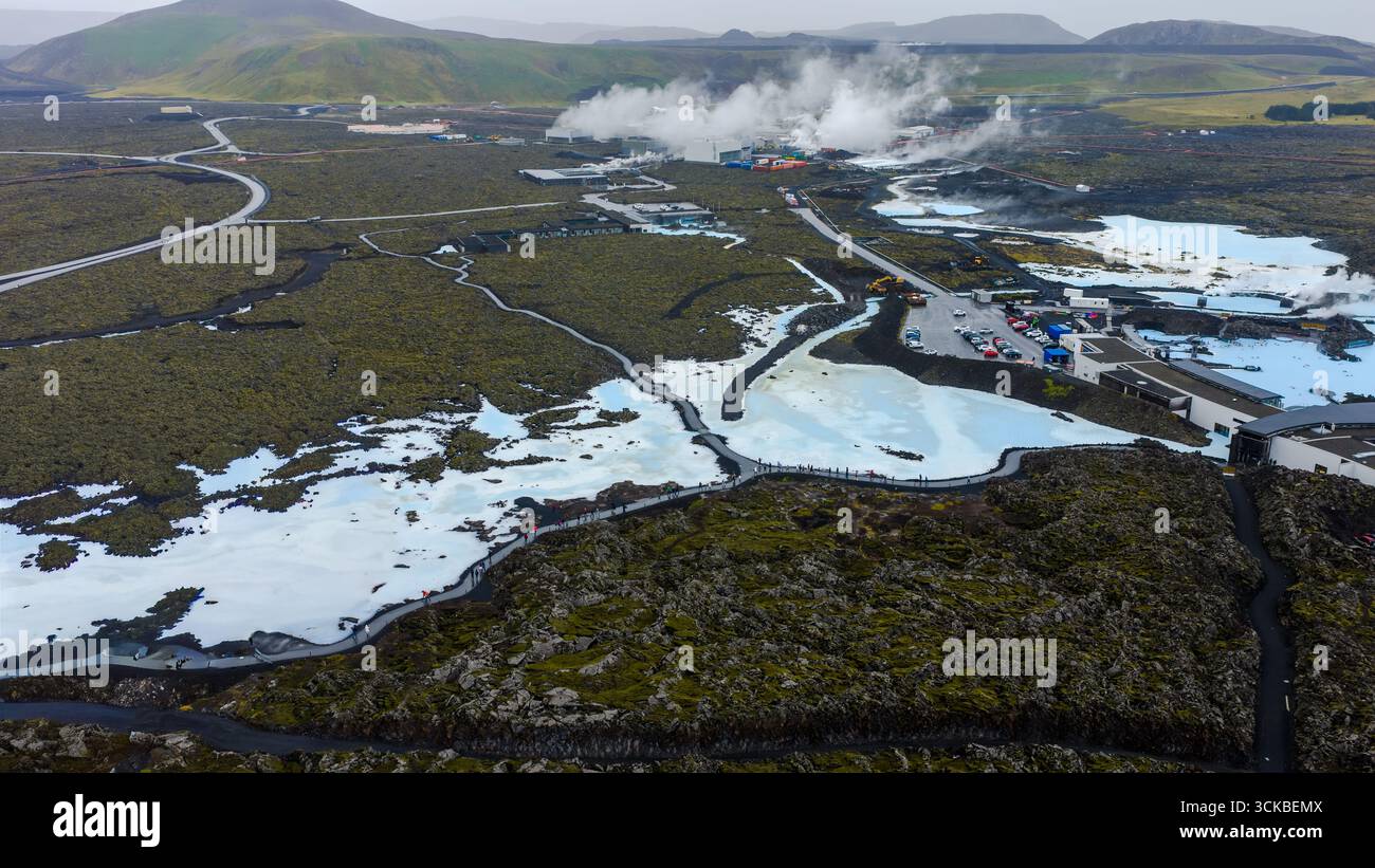 Milky blue waters of the Blue Lagoon contrast with dark lava fields ...