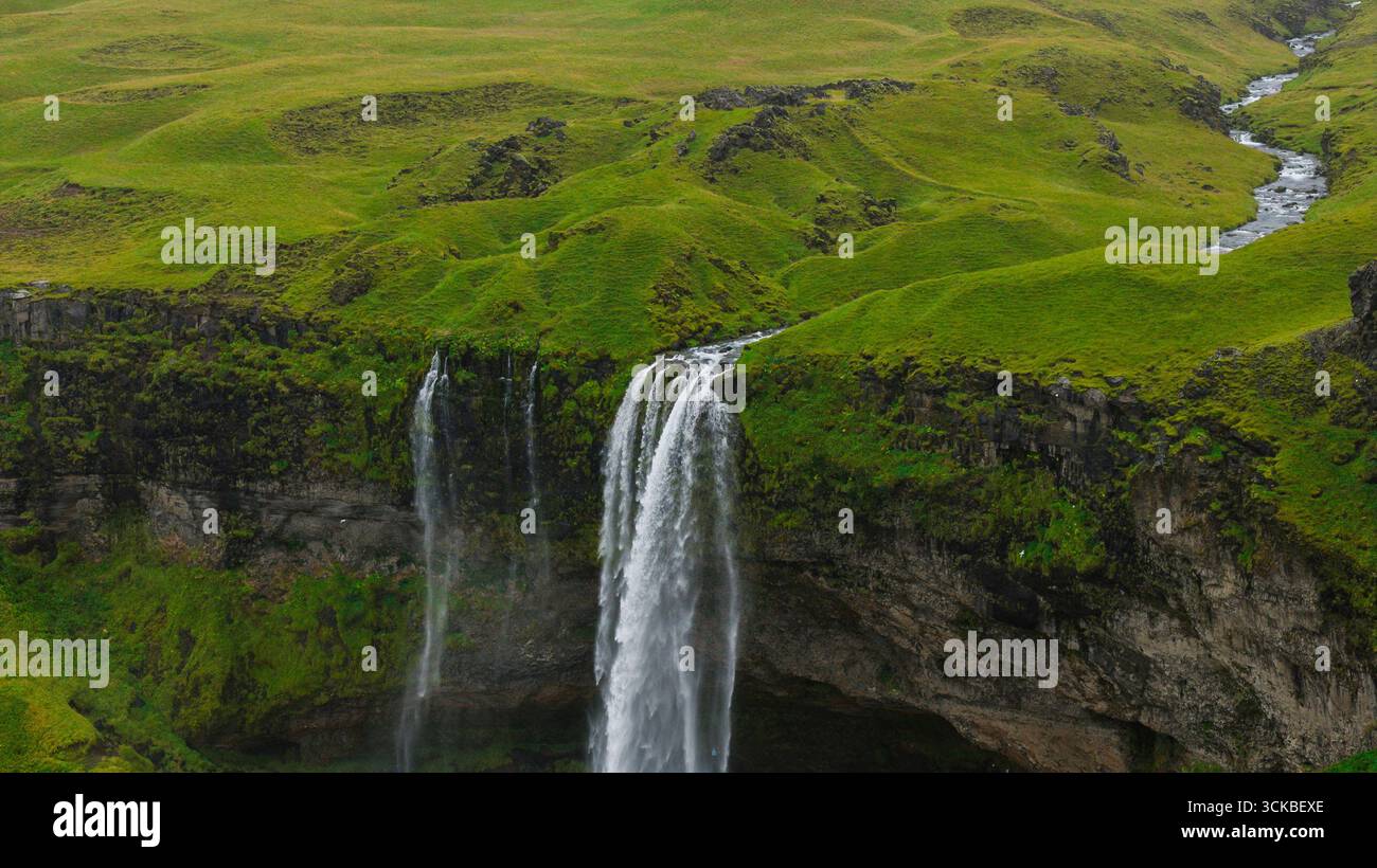 Tall waterfall cascades through lush hi-res stock photography and ...