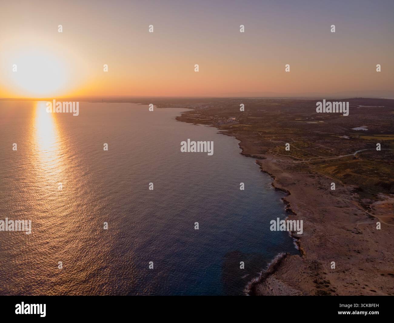 Aerial view of Cyprus coastline at sunset, featuring turquoise water ...