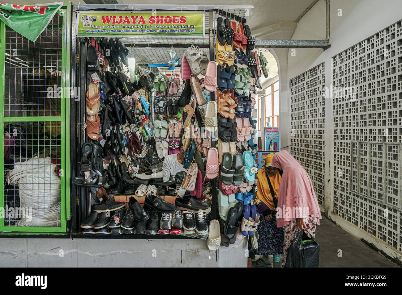A small shoe shop with various footwear displayed, including sandals ...