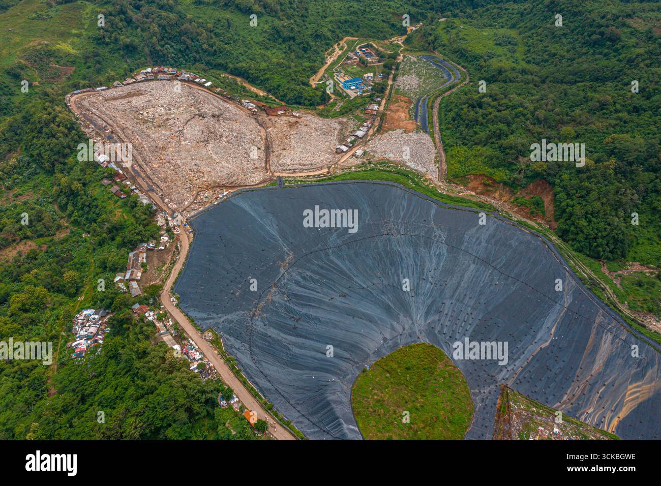 Aerial view of a large landfill site surrounded by greenery Stock Photo ...